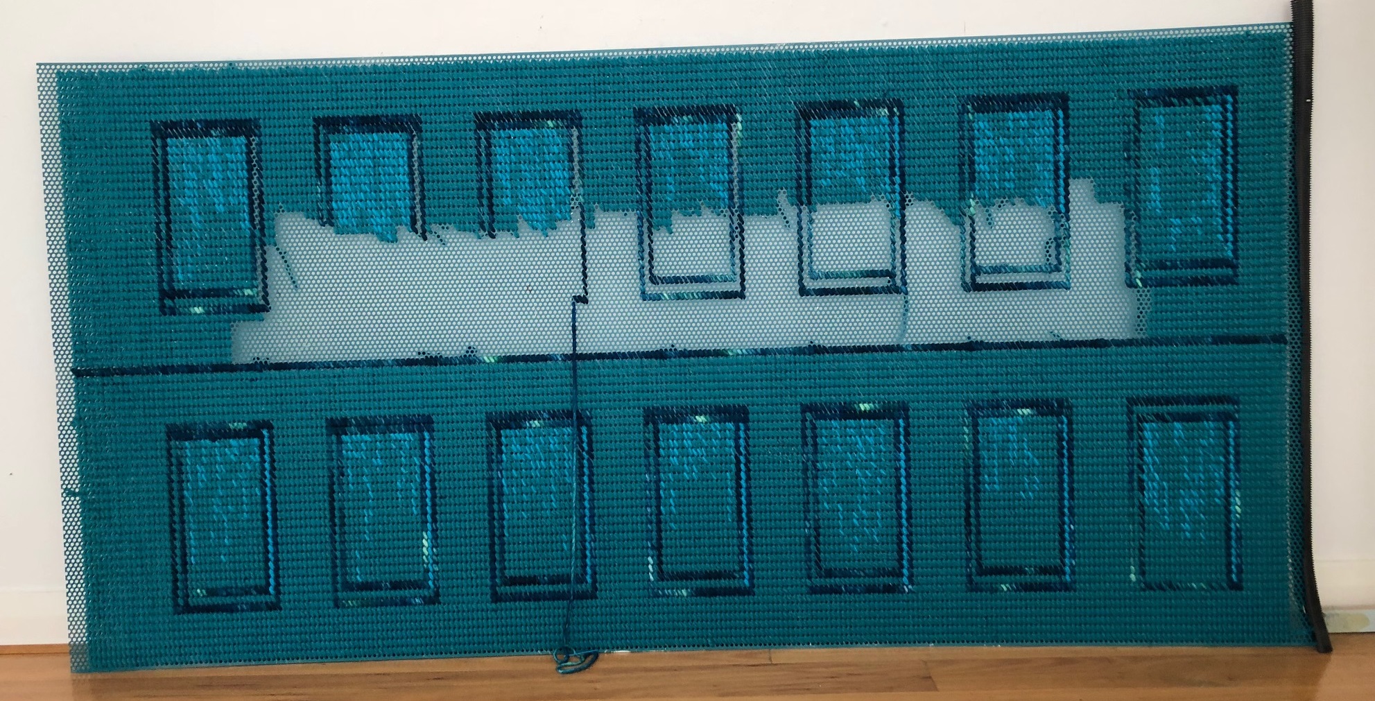 Arrow Metal perforated panel is threaded with wool to create arts ...